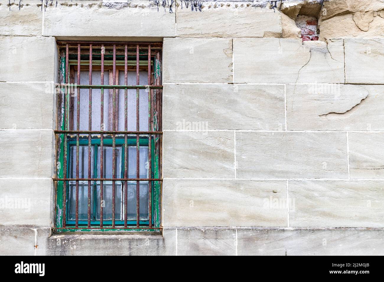 Old glass window behind bars of a prison building Stock Photo - Alamy