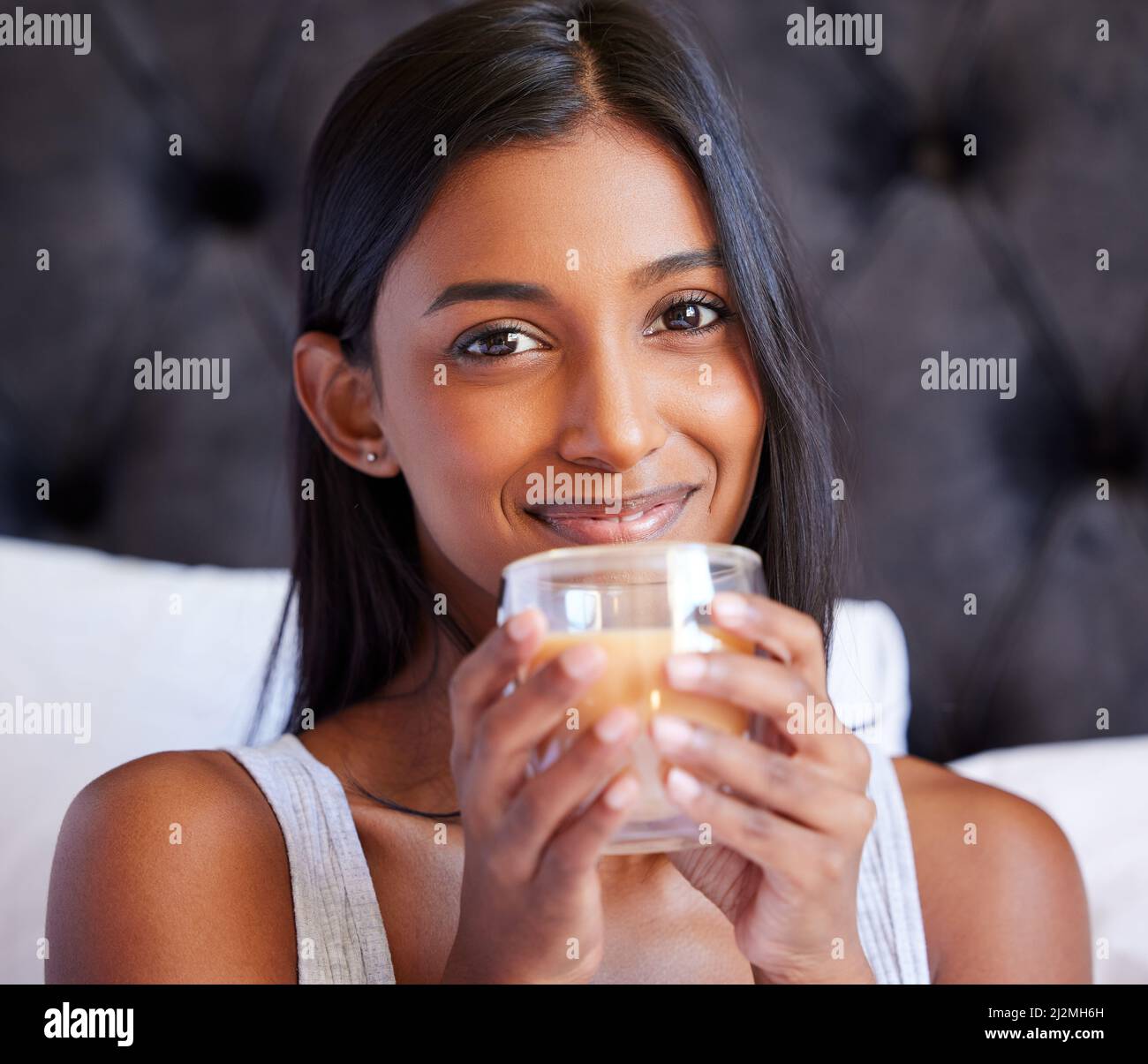 Its definitely a good morning. Shot of a young woman drinking a hot ...
