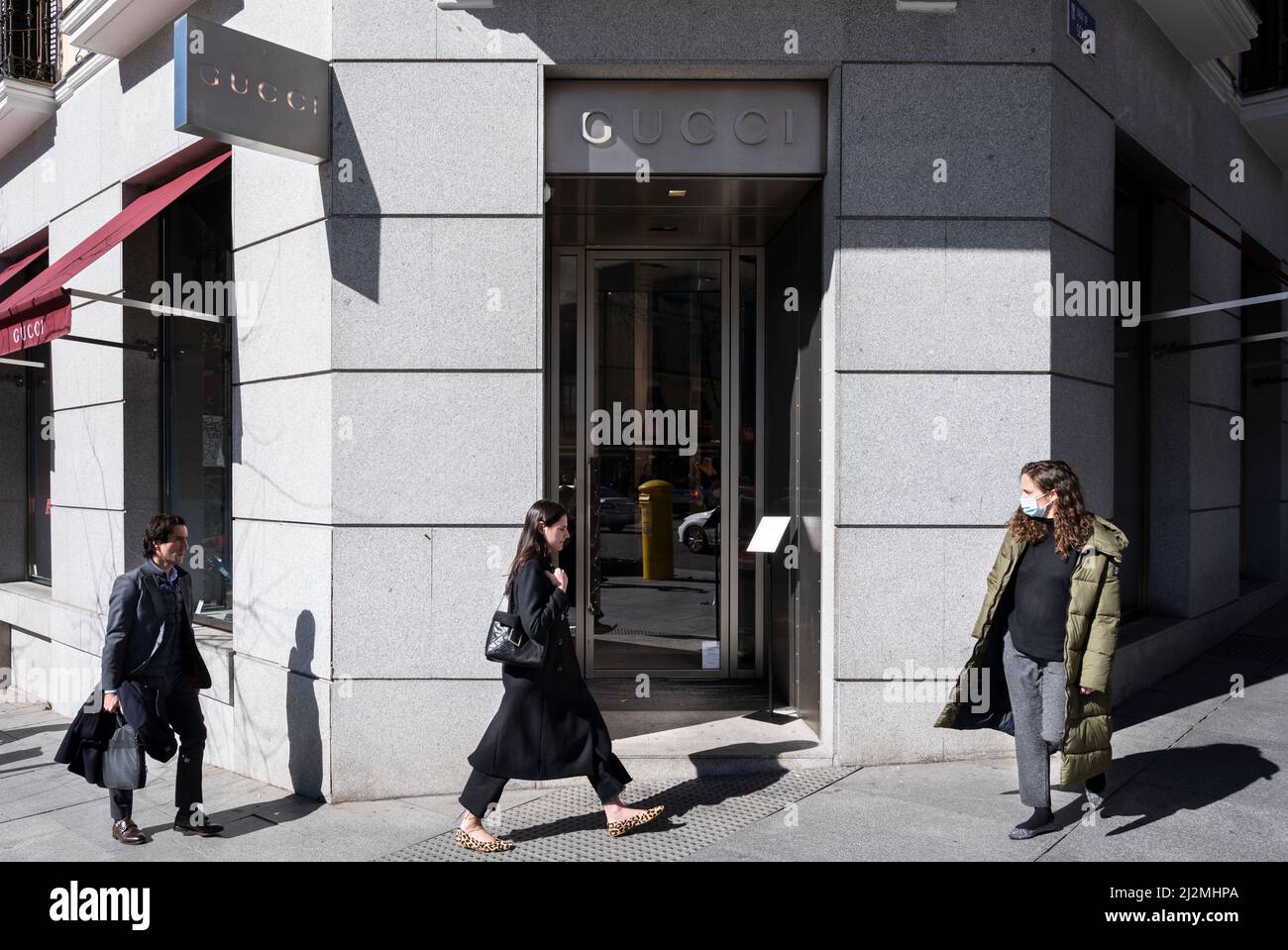 Pedestrians walk past the Italian luxury fashion brand Gucci store in ...