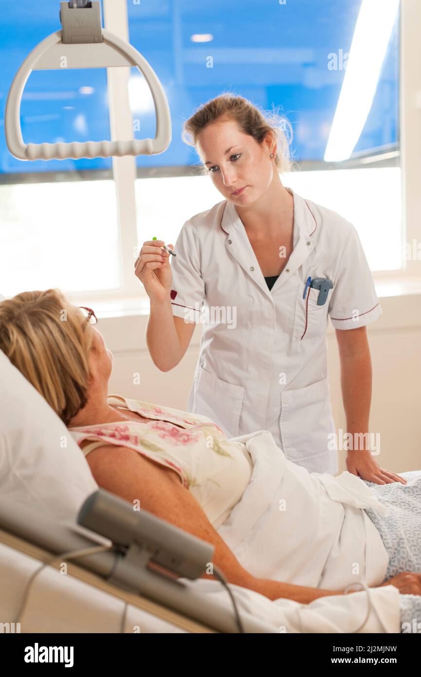 Nurse explaining how to administer an injection to a patient Stock ...