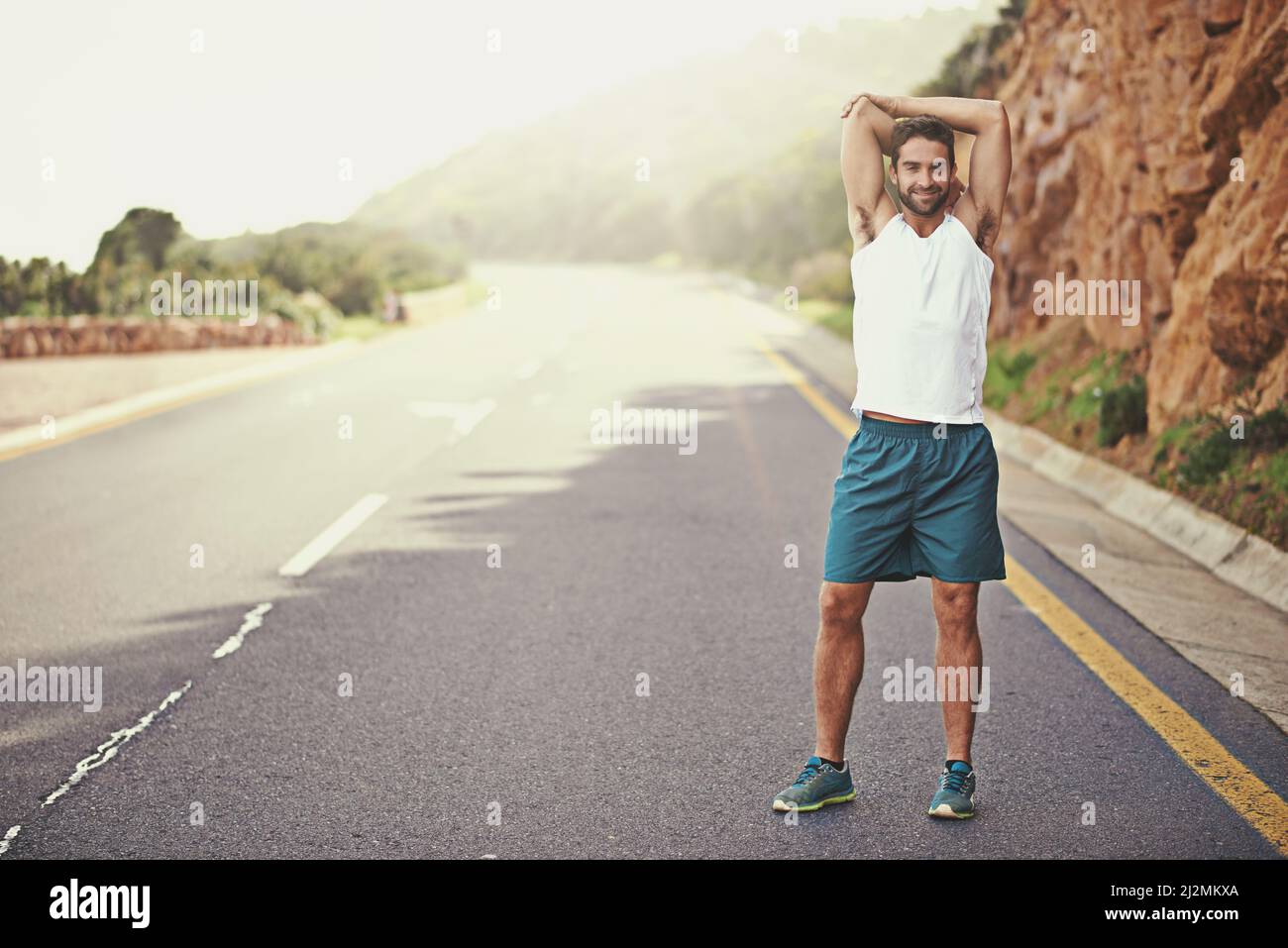 Im ready to run. Are you. Portrait of a young man stretching before ...