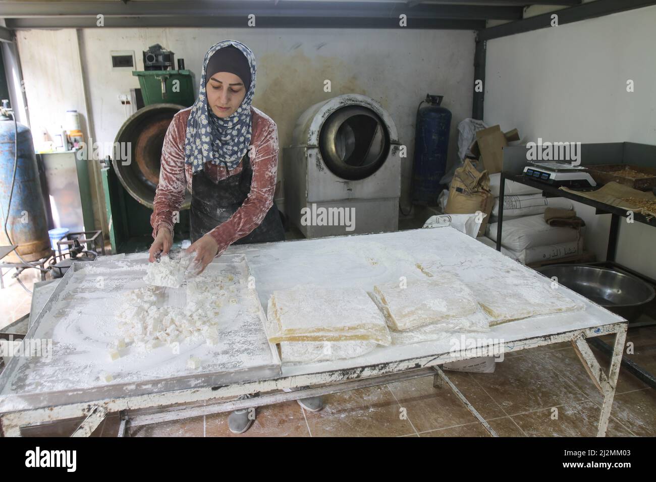 Nablus, Palestine. 02nd Apr, 2022. A Palestinian woman prepares sweet ...