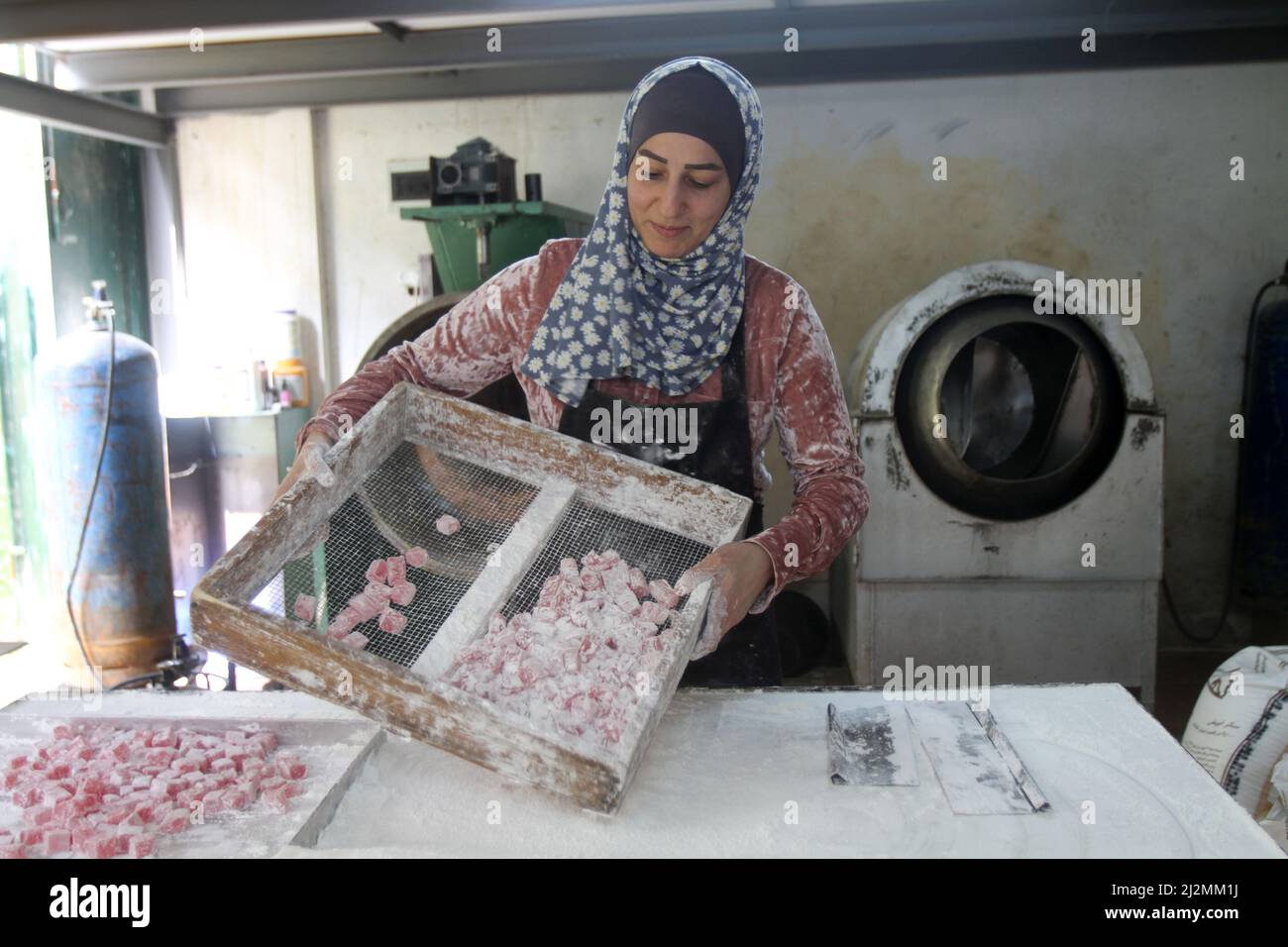 A Palestinian woman prepares sweet (halqum), an Iraqi-Turkish dessert ...