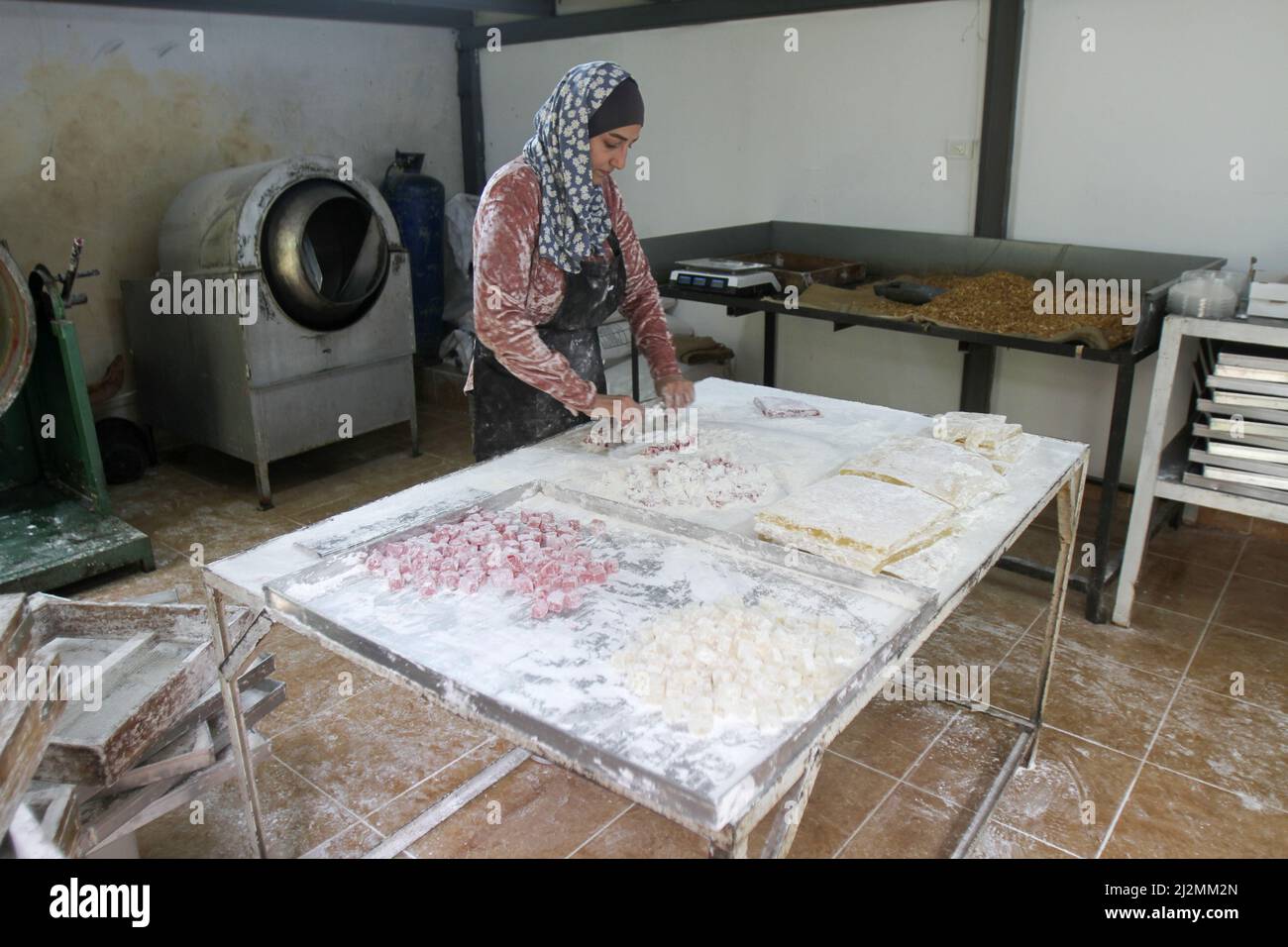 A Palestinian woman prepares sweet (halqum), an Iraqi-Turkish dessert ...