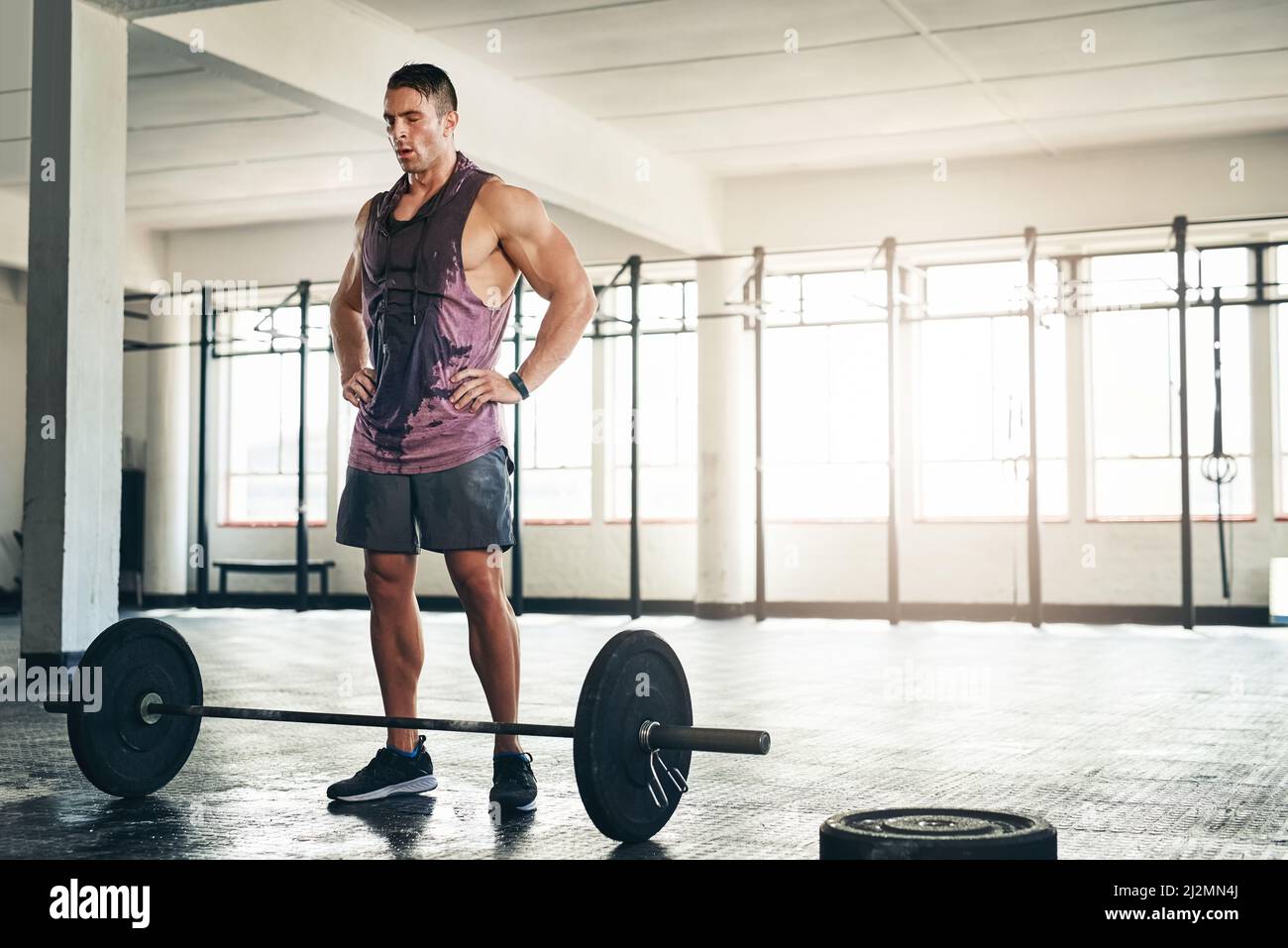 Getting firm through the burn. Shot of a muscular young man lifting ...