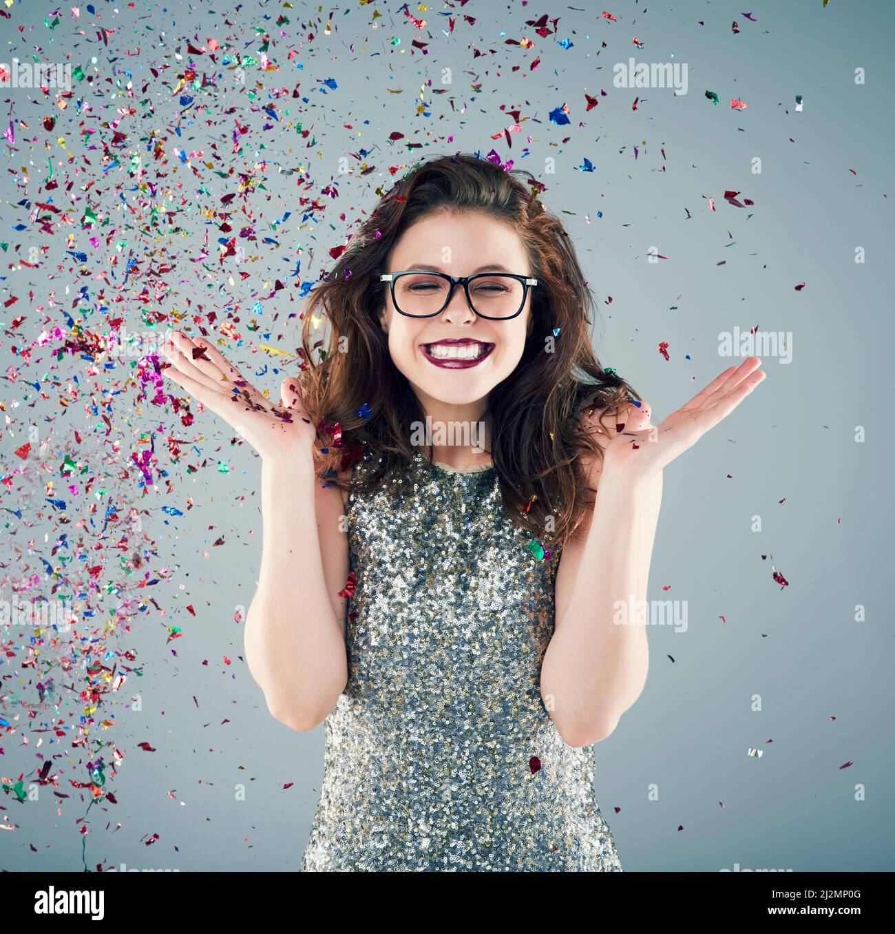 Toss some confetti in the air and celebrate. Studio shot of a young ...