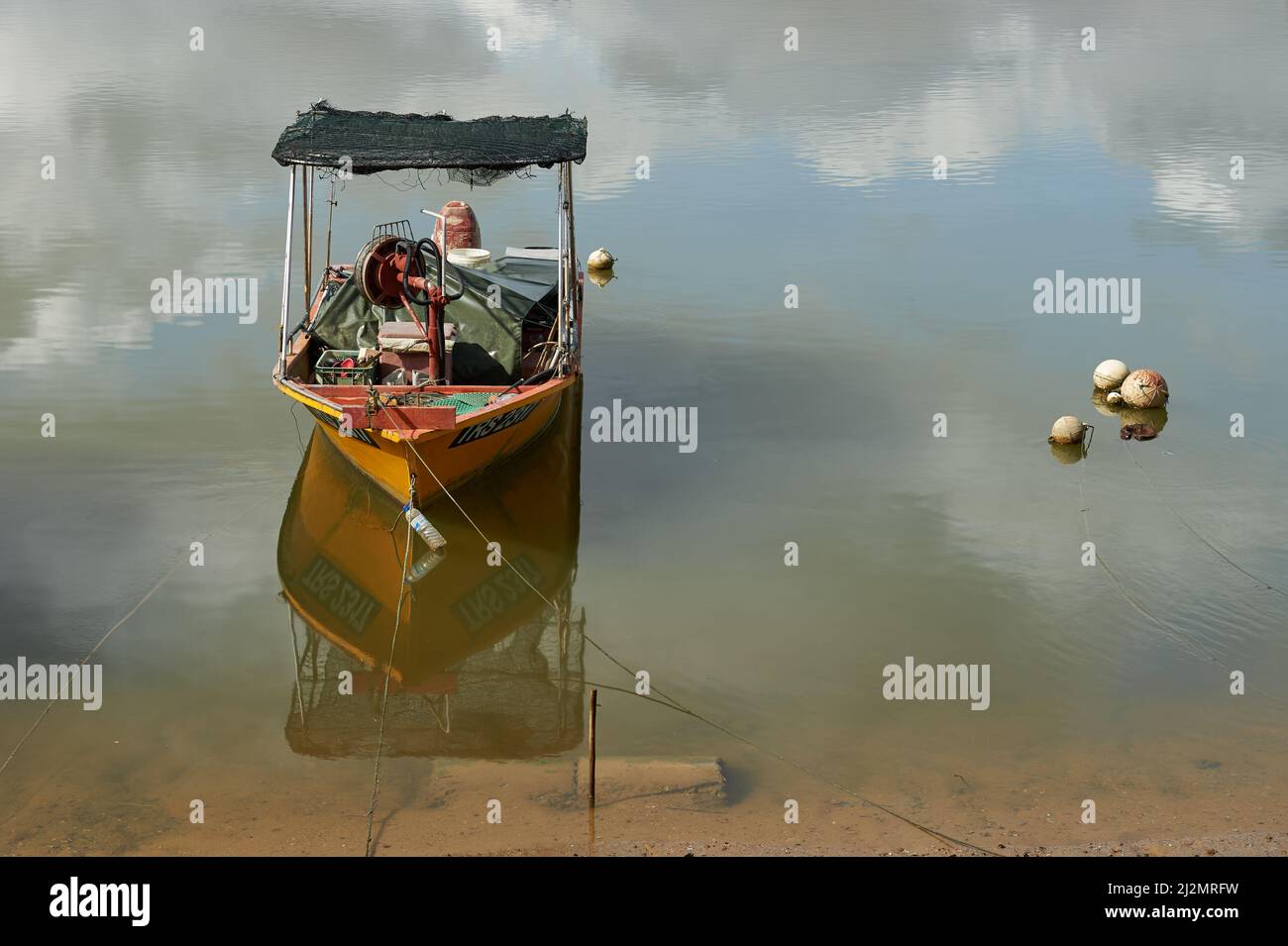 small single fisherman boat anchored by the beach Stock Photo - Alamy
