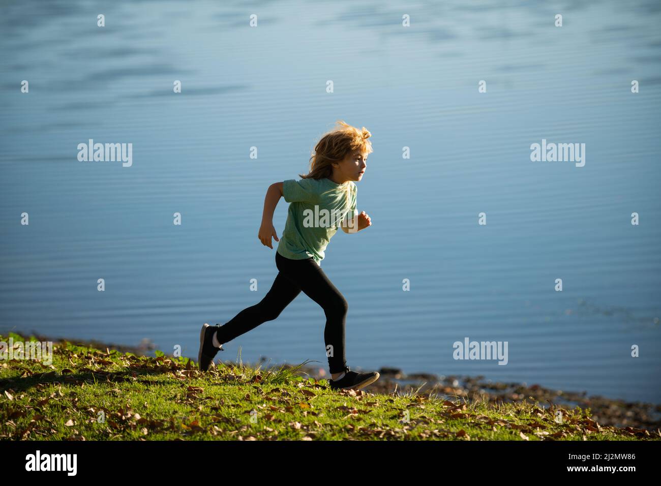 Kids running outdoors. Sporty young child jogging and training outdoor ...