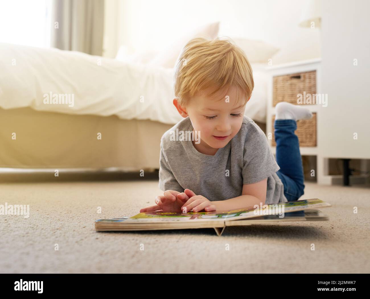 Im slowly learning to read all the big words now. Shot of a young boy ...