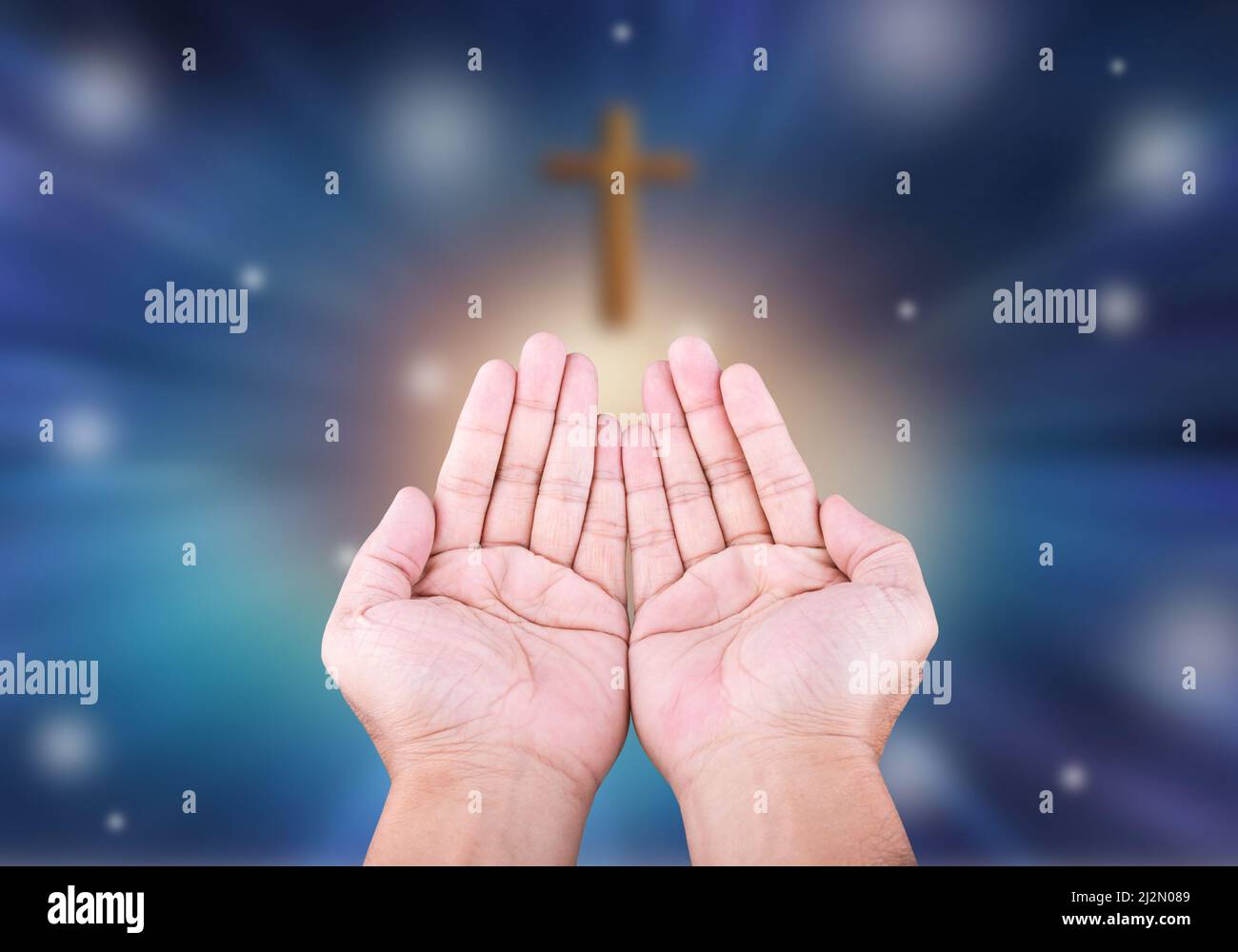 Human hand with a prayer to the holy cross Stock Photo - Alamy