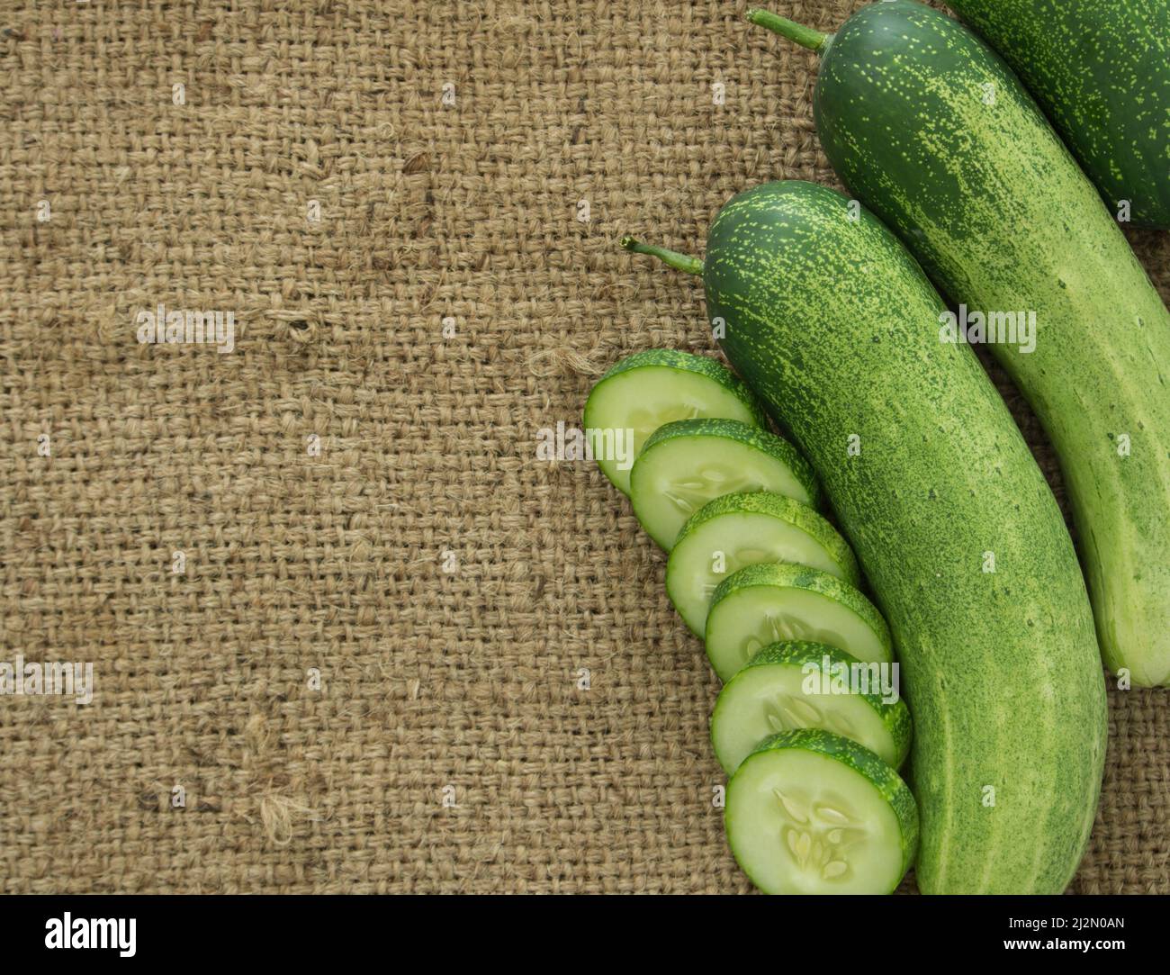 cucumbers and cucumber slice on sack background Stock Photo - Alamy
