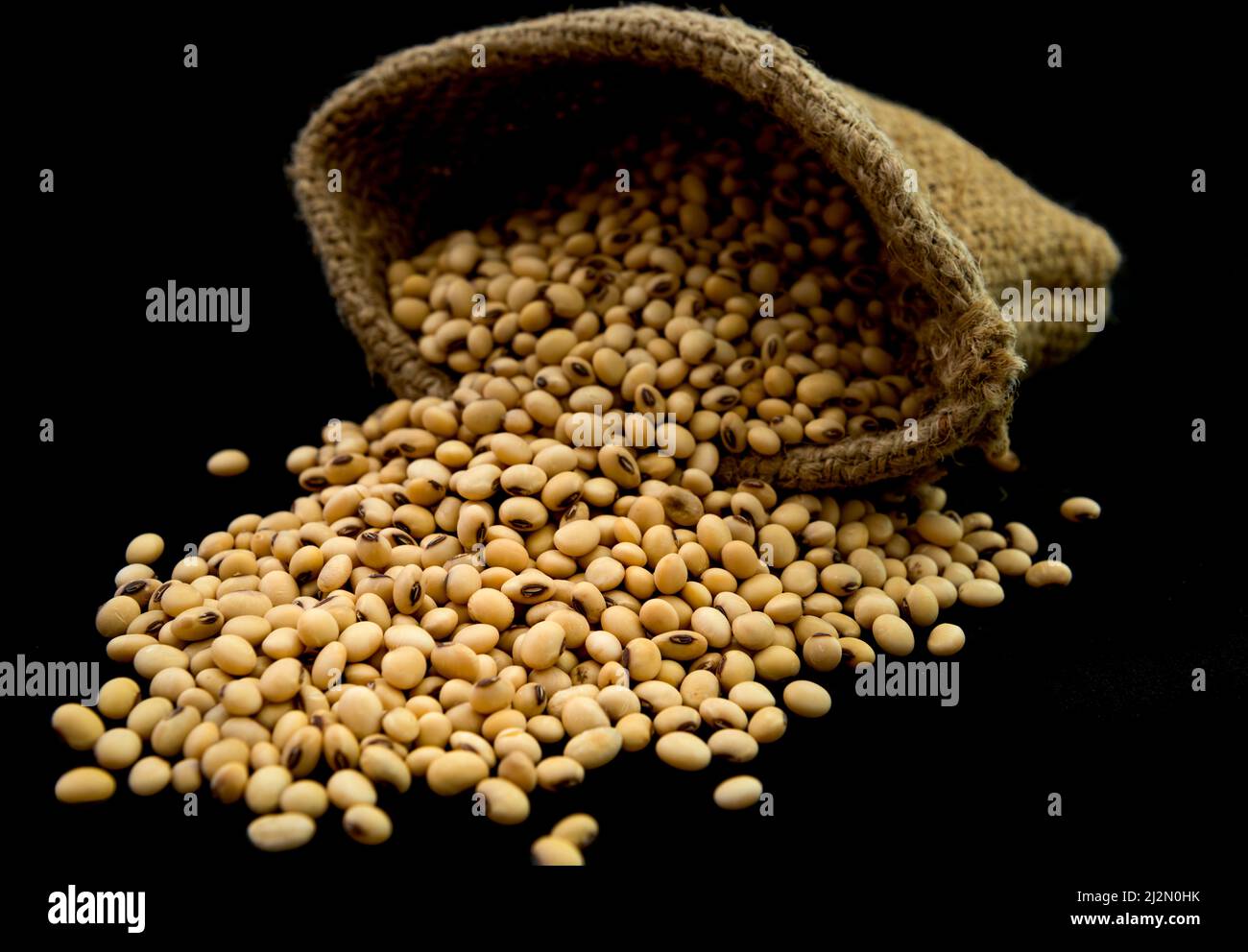 Soybean in sack on a black background Stock Photo - Alamy