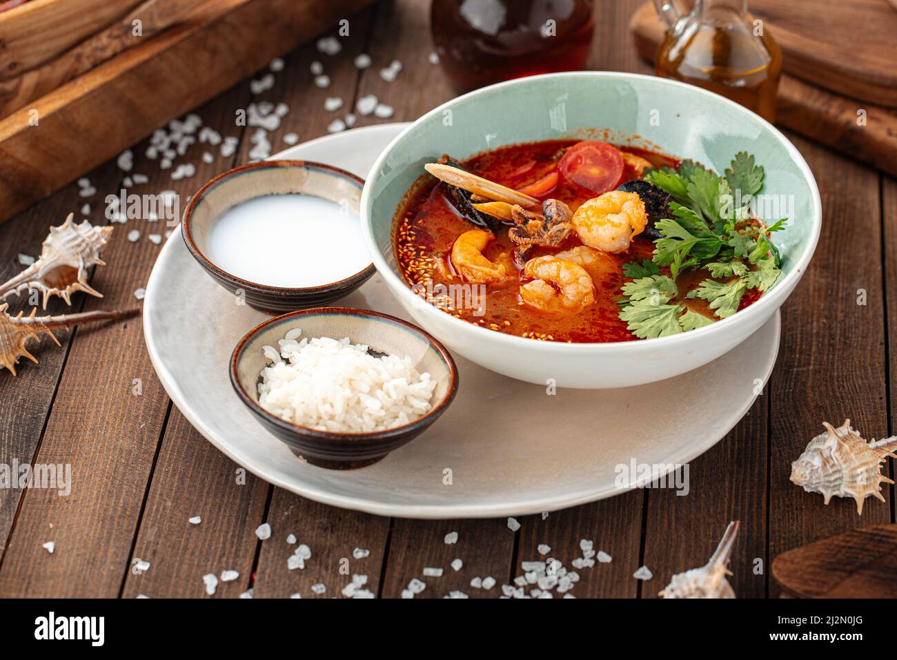 Bowl of thai seafood tom yam soup with rice Stock Photo - Alamy