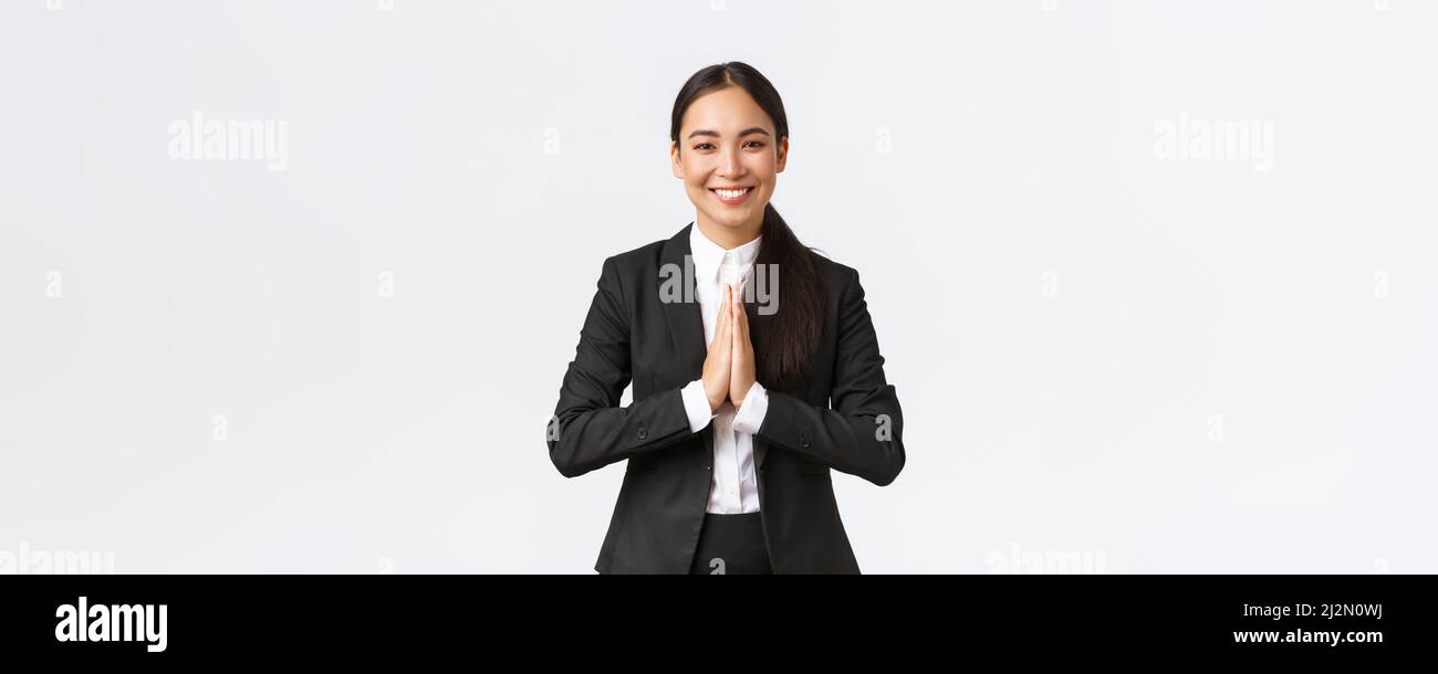 Hopeful glad asian businesswoman in black suit bowing politely and say ...