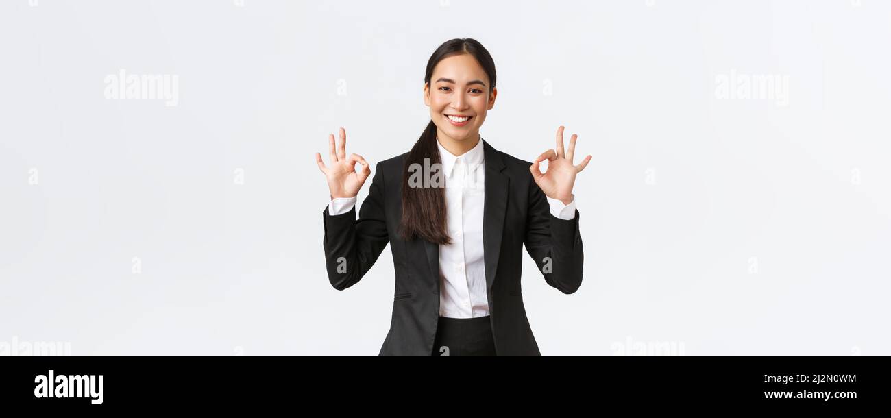 Professional pleasant saleswoman showing okay gesture, selling house ...