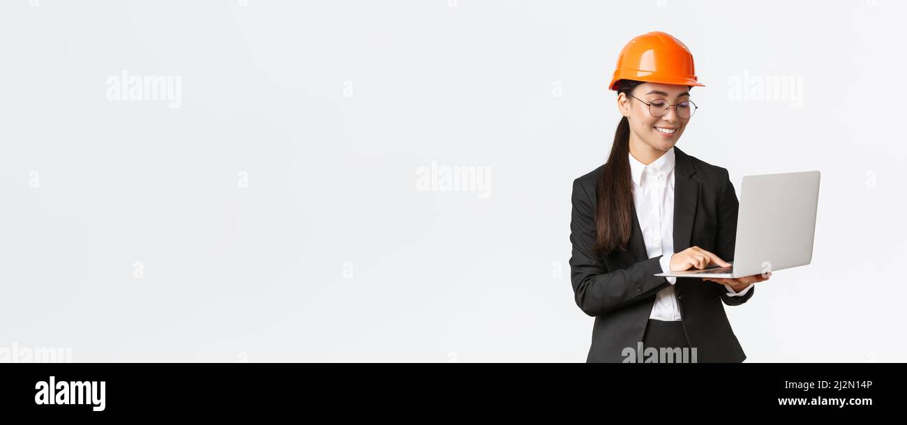 Smiling successful female asian industrial engineer, factory manager in ...