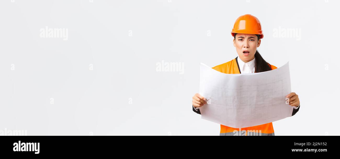 Frustrated and displeased female asian engineer, chief architect at ...