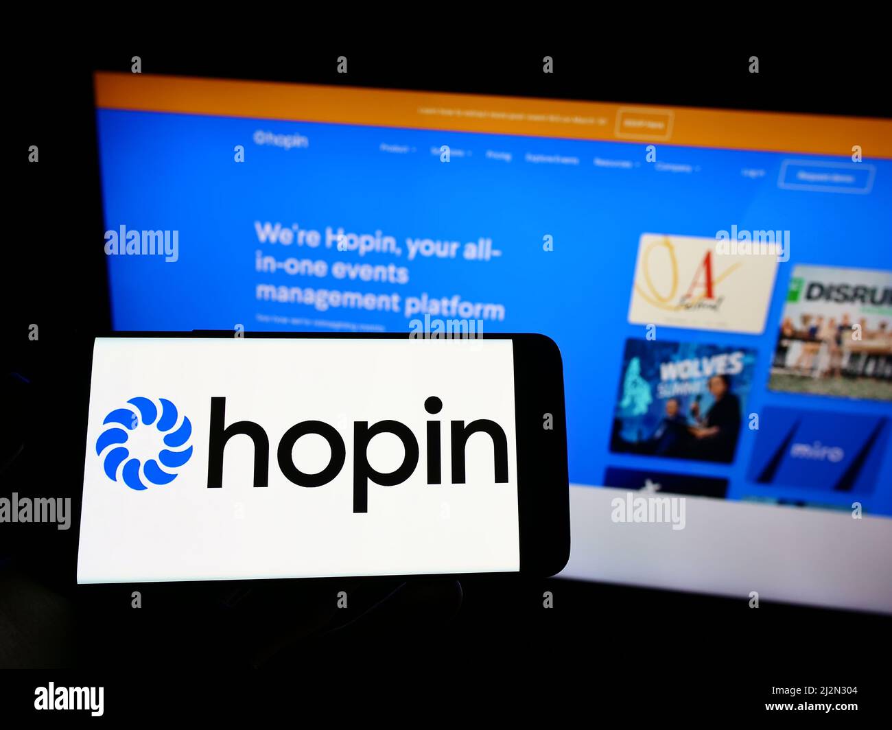 Person holding cellphone with logo of British event management company ...