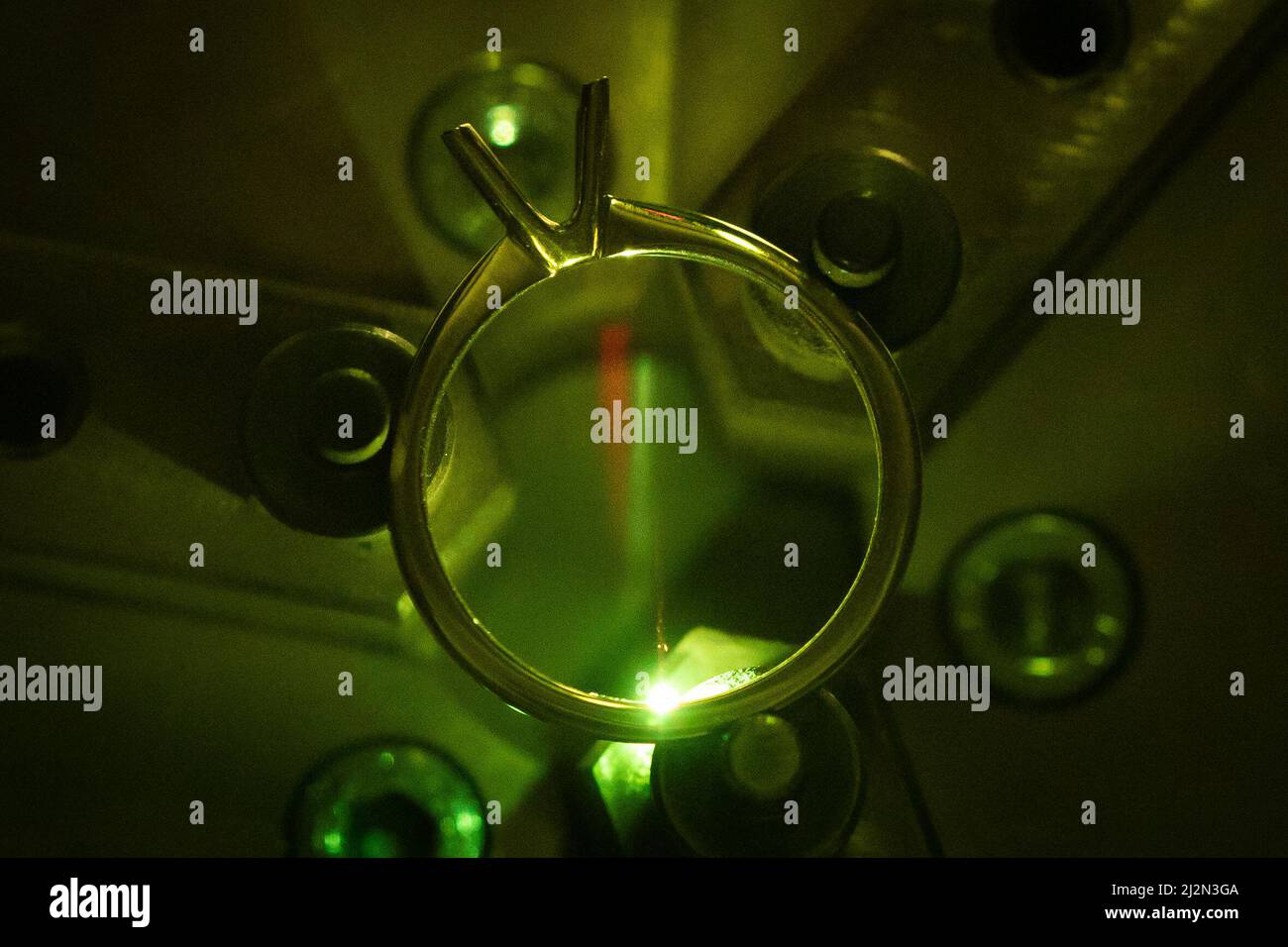 An engagement ring is laser engraved at a 77 Diamonds workshop in ...