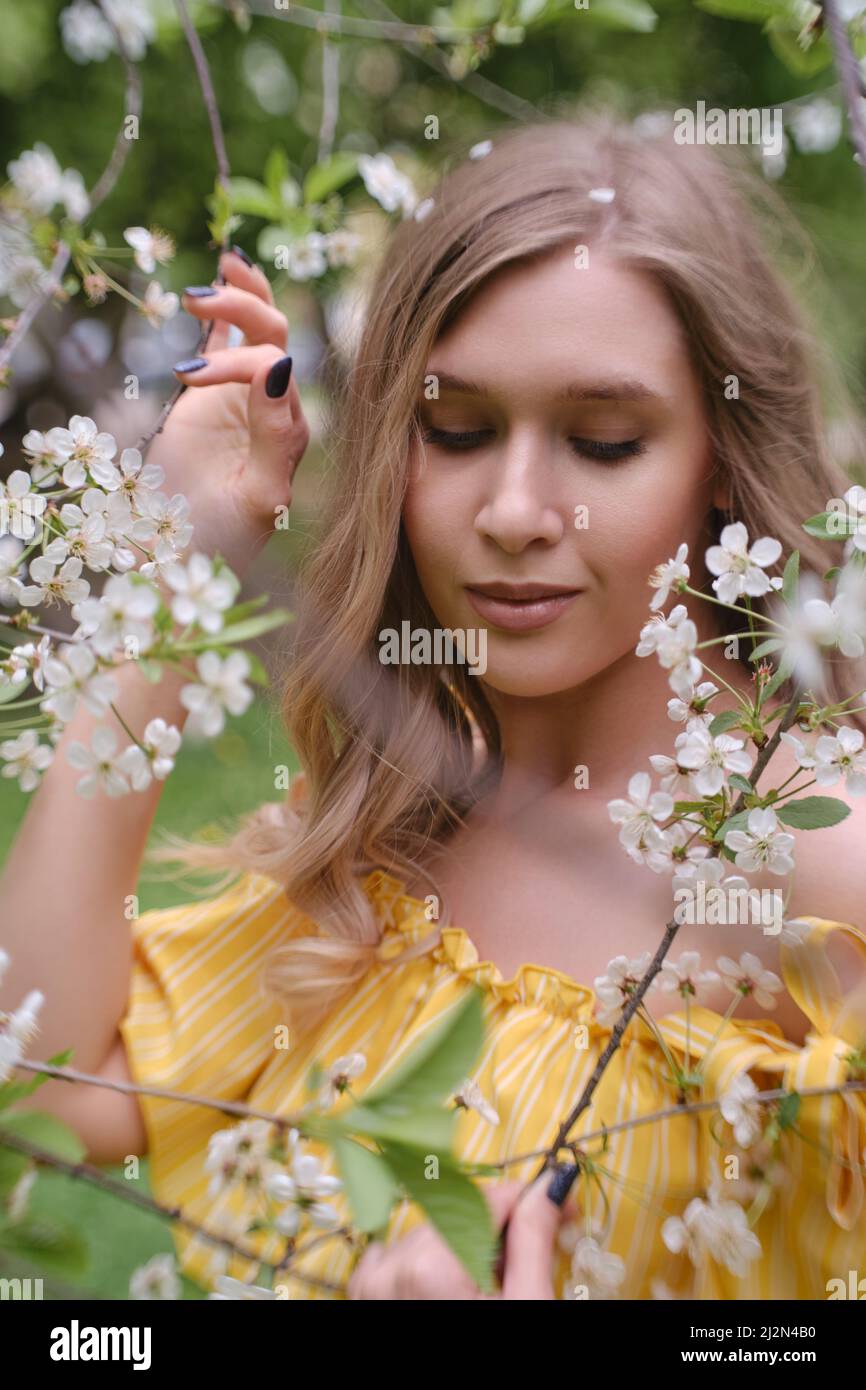 beautiful blonde woman near cherry blossoms close up portrait Stock ...