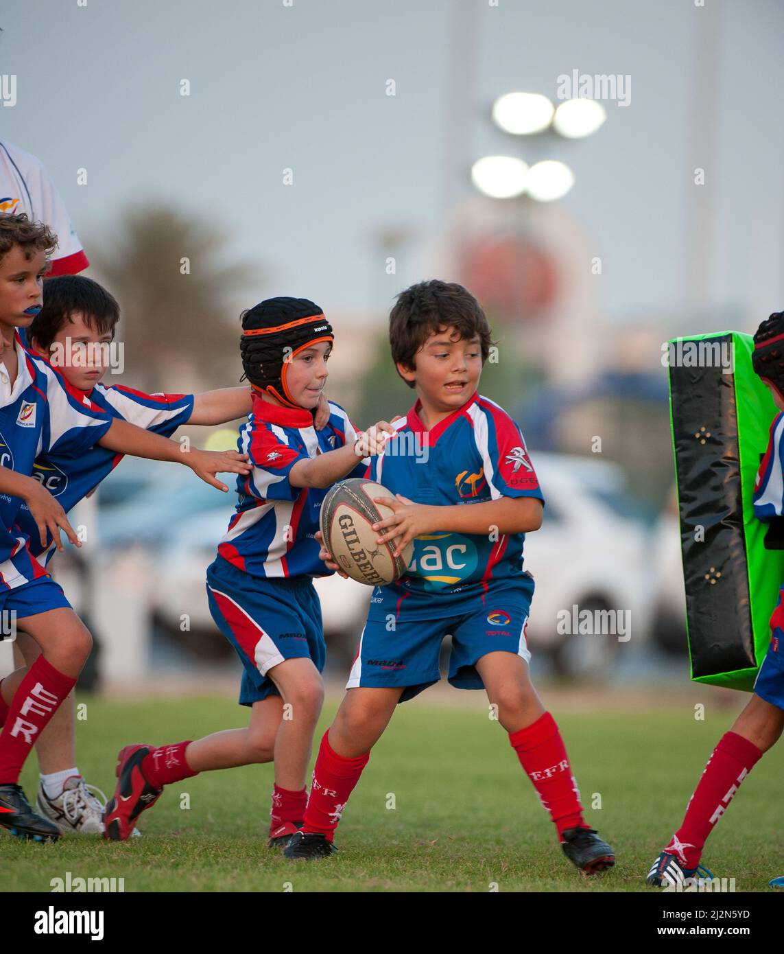 young kids playing rugby in abu dhabi Stock Photo - Alamy