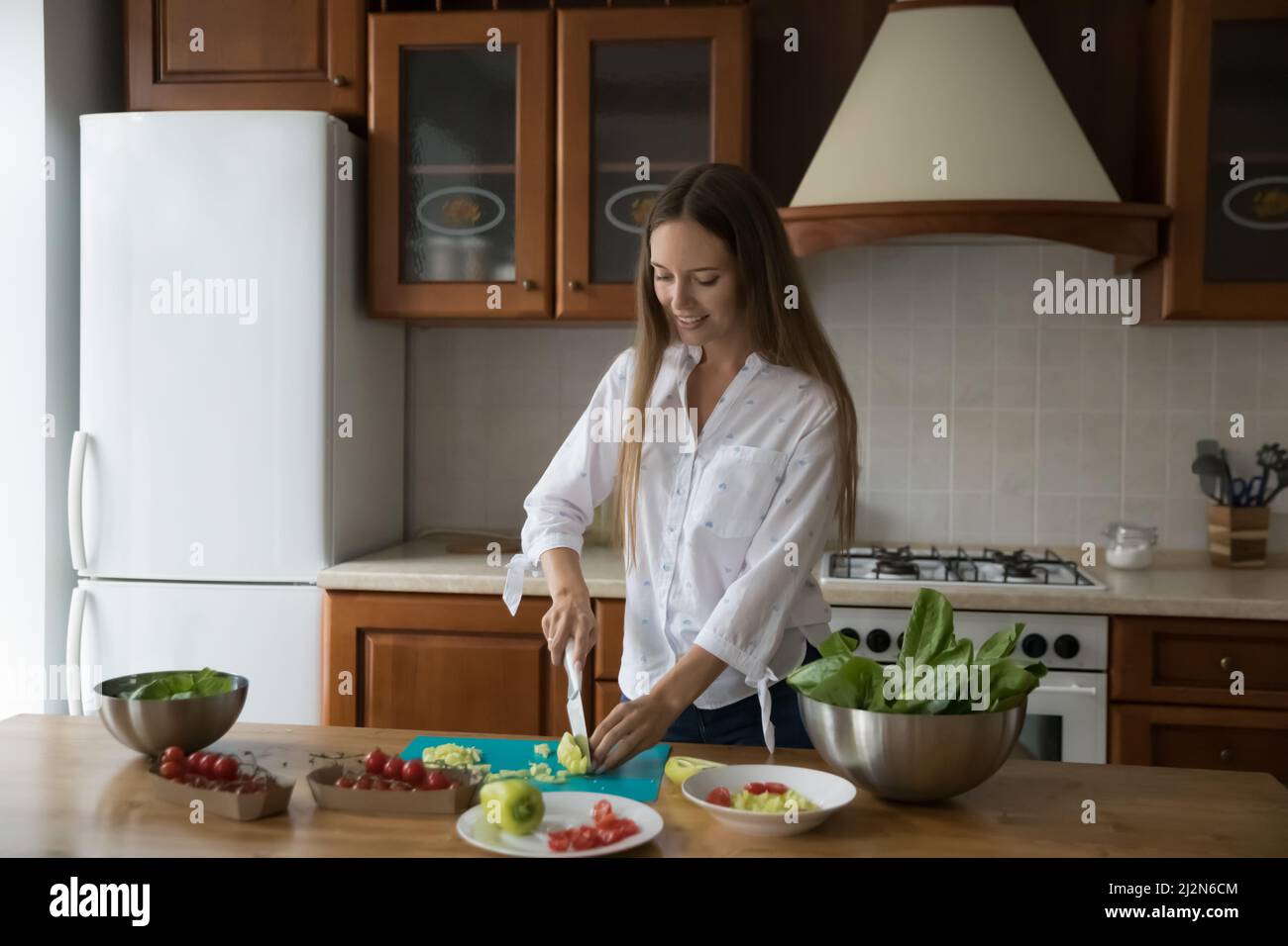 Happy beautiful chef girl cooking healthy dinner Stock Photo - Alamy