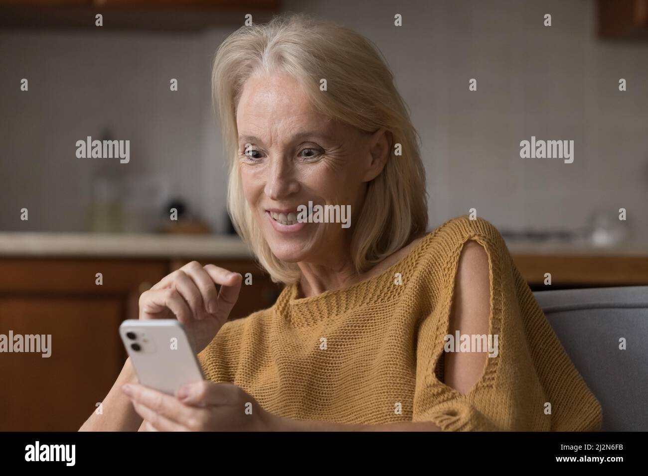 Excited surprised senior smartphone user woman reading text message ...