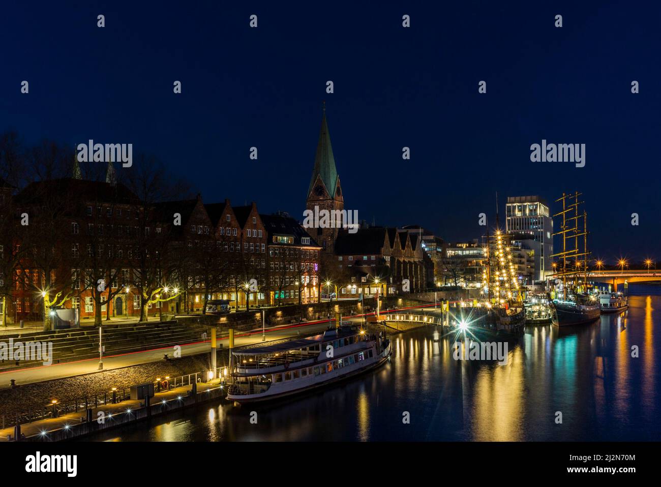 Night view of Bremen with the buildings, bridges and ships reflecting ...