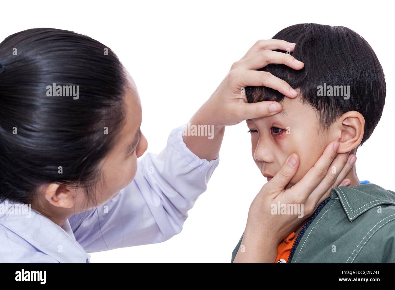 Little asian boy with an injured eye. Doctor examining and first aid a ...