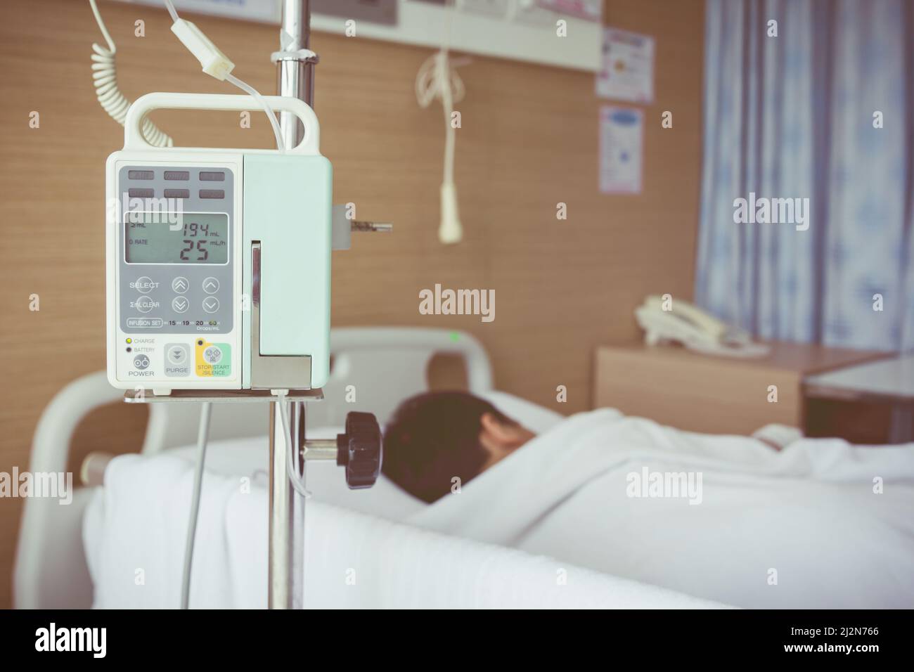 Illness asian boy lying on sickbed in hospital with infusion pump ...