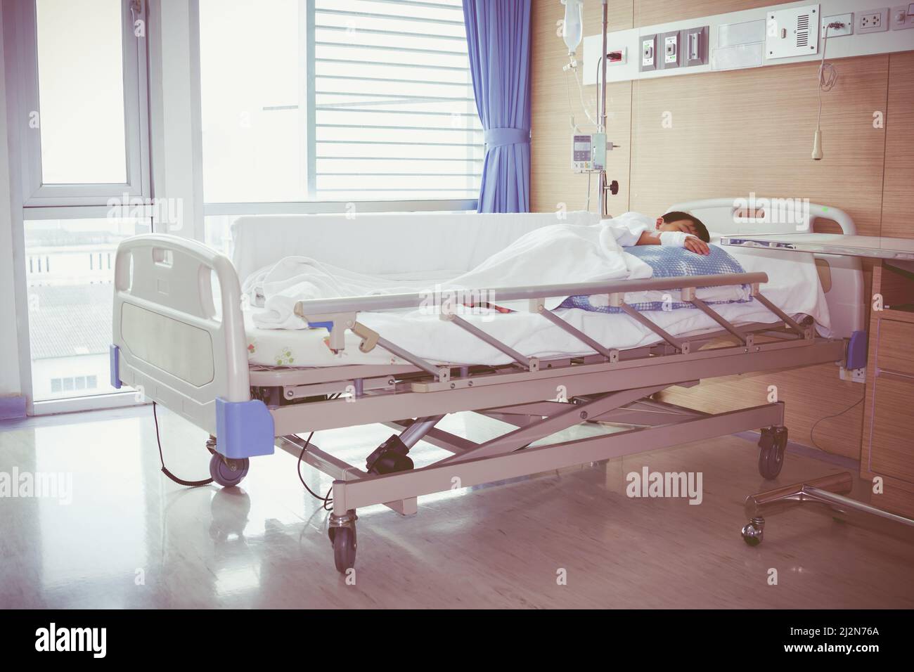 Illness asian boy sleeping at modern and comfortable equipped hospital ...