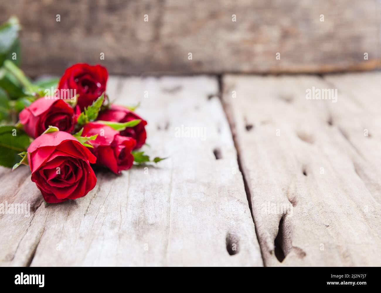 Bouquet of beautiful red roses for Valentine's Day on blurred wooden ...