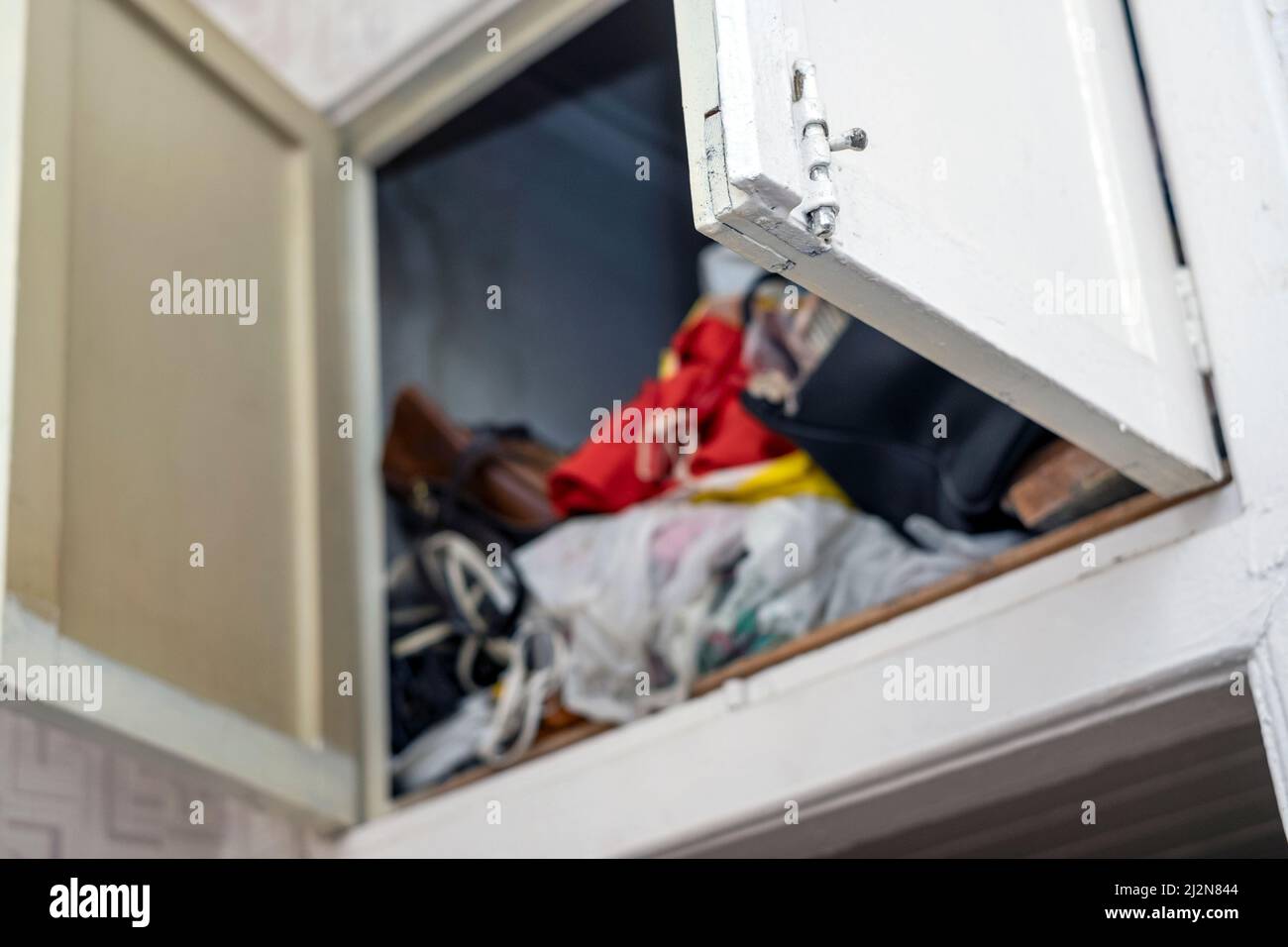 open doors of a pantry full of messy stuff, indoor shot Stock Photo - Alamy