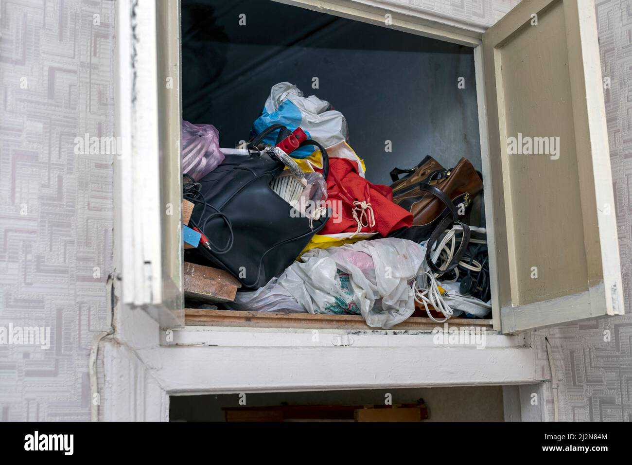an open closet full of old household goods, collected for future use ...