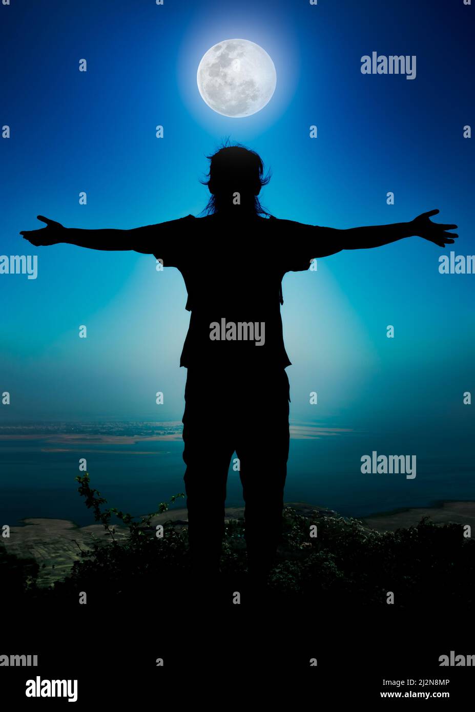 Back view of happy woman relaxing and stretch the arms with full moon ...