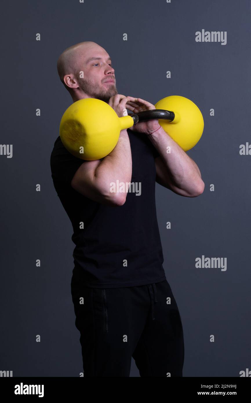 Guy with a yellow kettlebell gym anonymous young strength, from fit ...