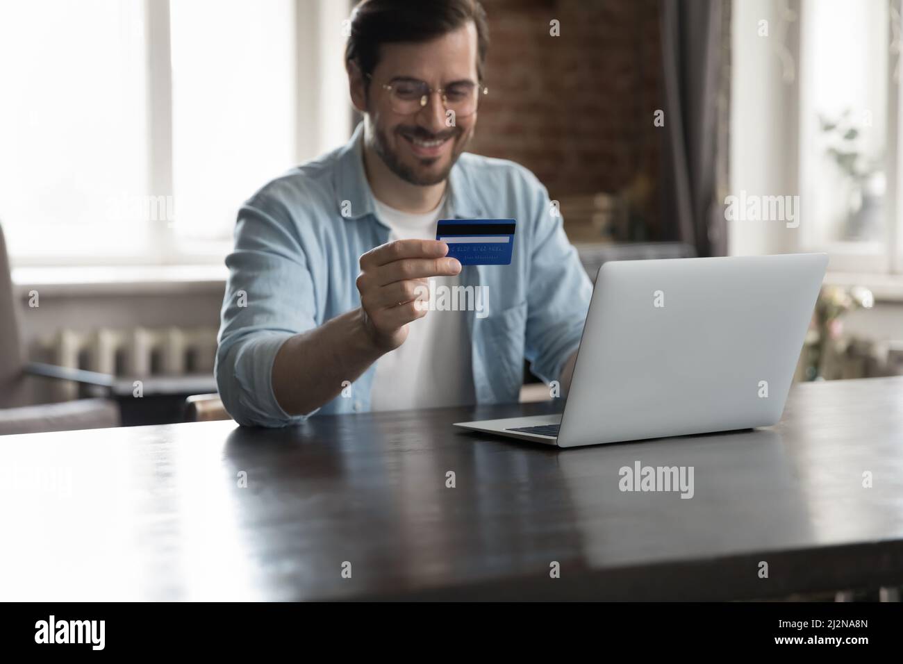 Happy cheerful bank customer man using laptop and credit card Stock ...