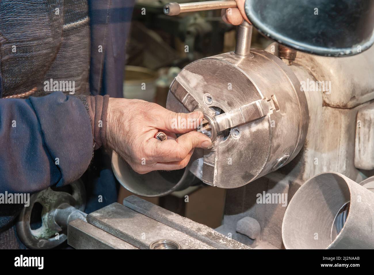 worker uses his hands to make the final polishing of stainless steel ...