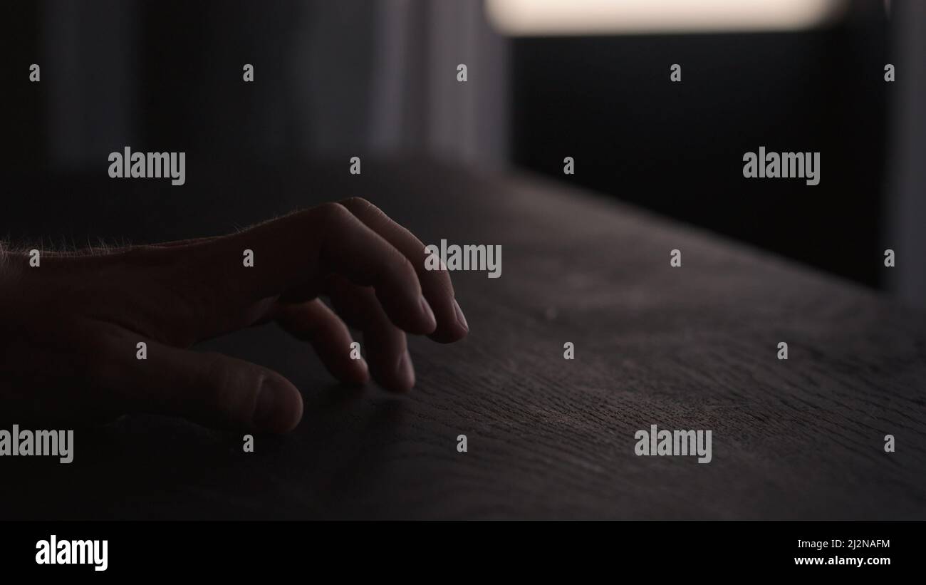 man hand finger tapping on black oak table with copy space, wide photo ...