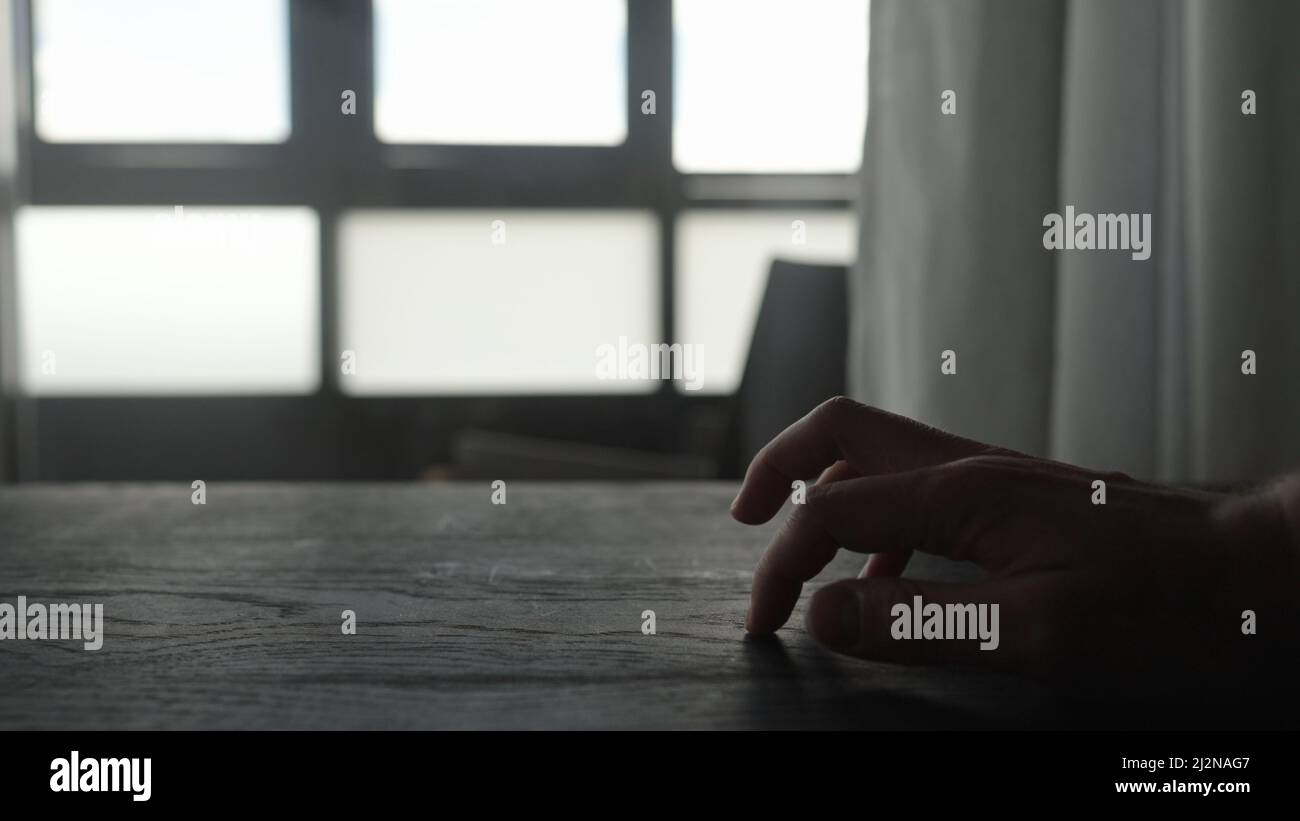 man hand finger tapping on black oak table with copy space, wide photo ...