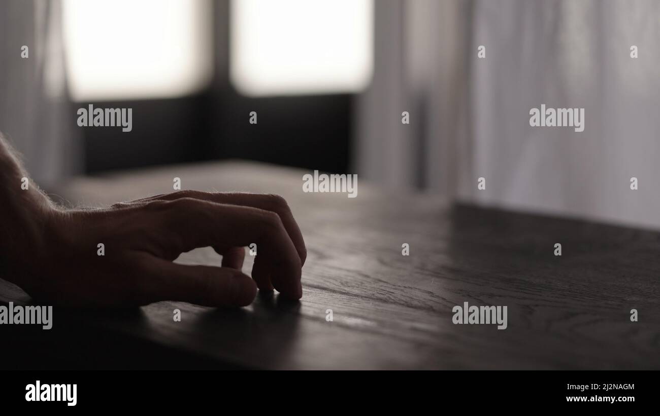 man hand finger tapping on black oak table with copy space, wide photo ...