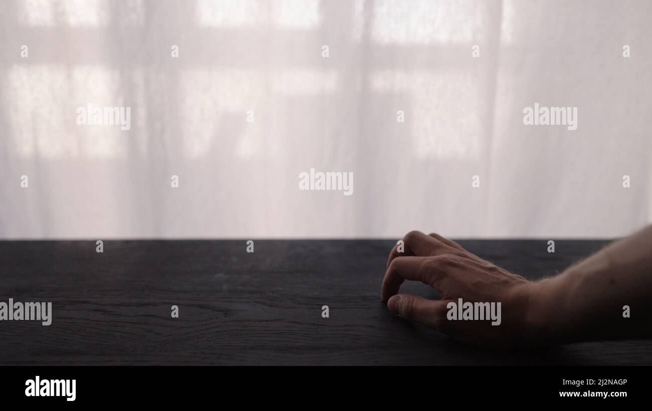 man hand finger tapping on black oak table with copy space, wide photo ...
