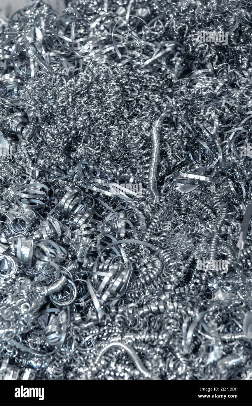 Metal shavings. Background of metallic chips. Processing of ferrous metals in a factory. Metal ...