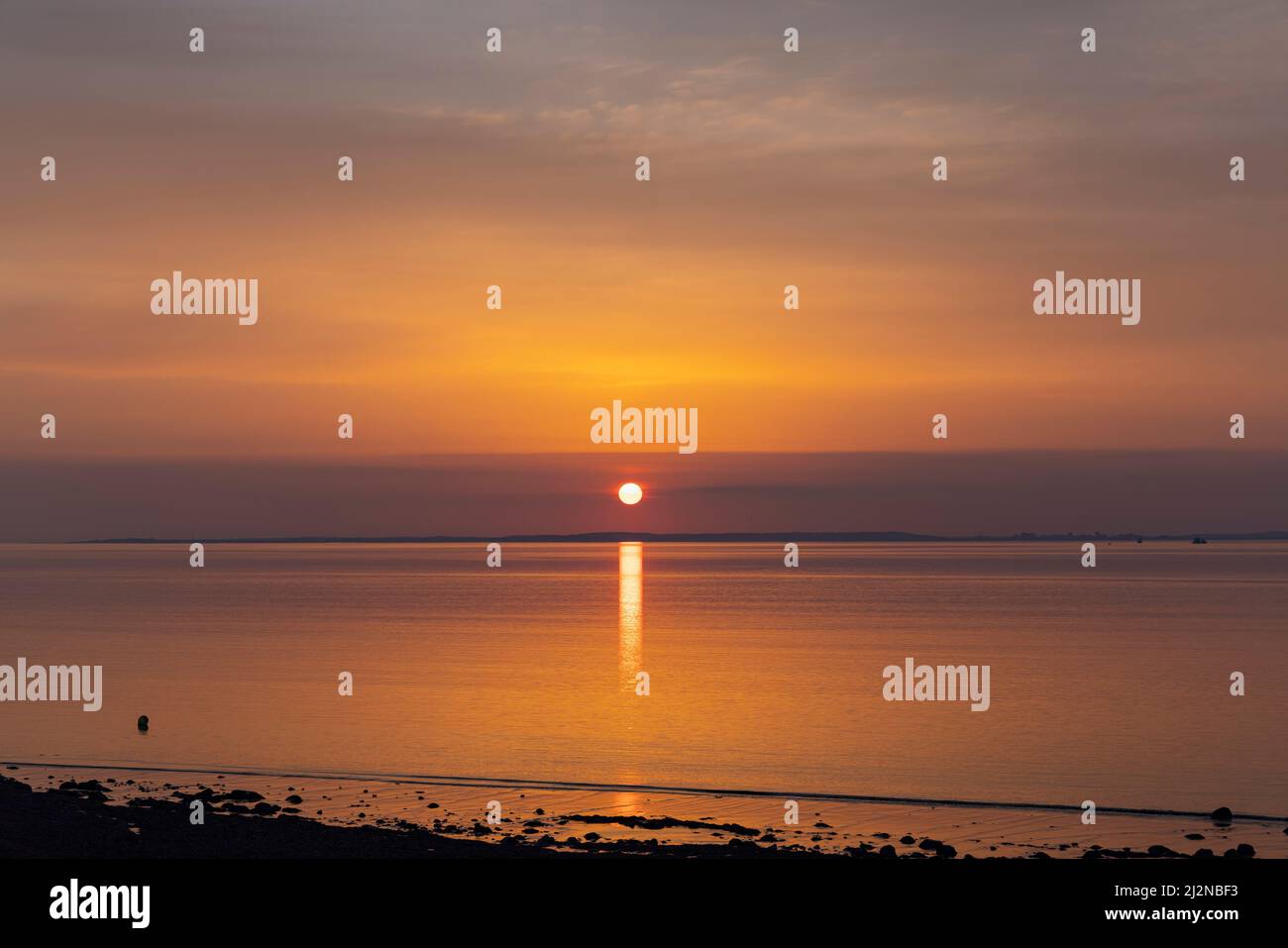 Sunset over the Bristol channel with a streak of sunlight Stock Photo ...