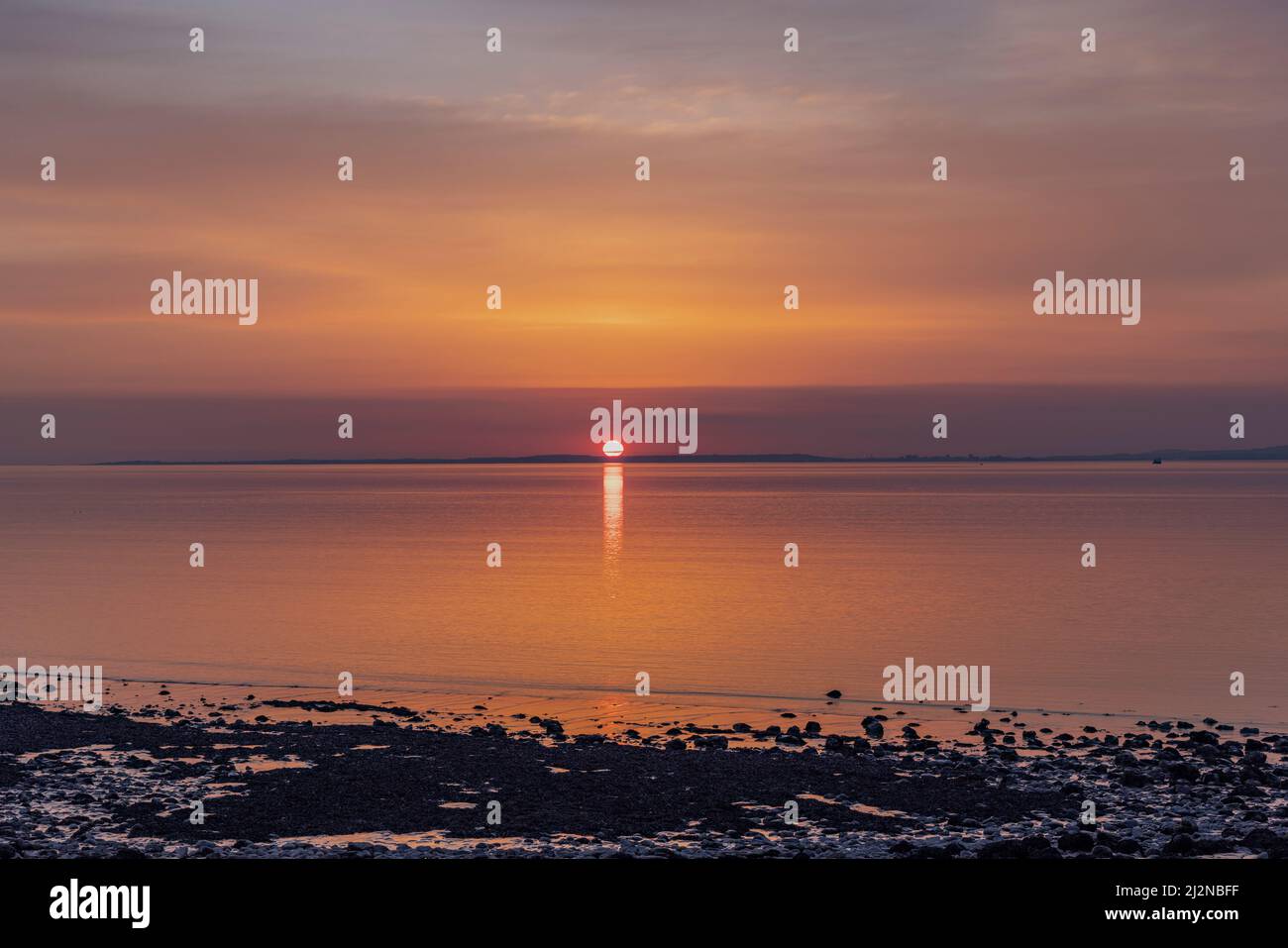 Sunset over the Bristol channel with a streak of sunlight Stock Photo ...