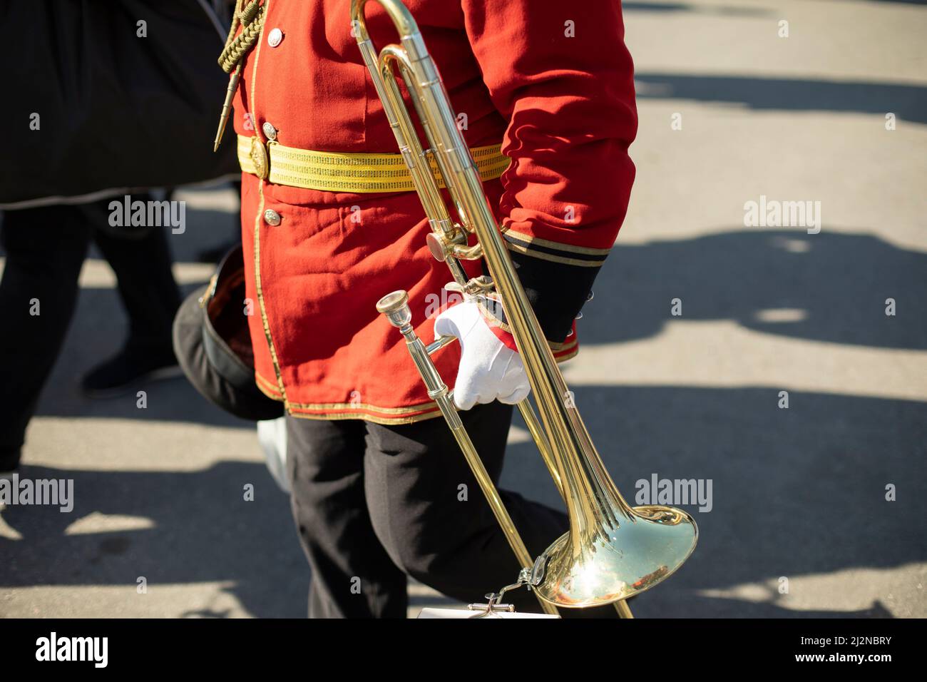 Orchestra member holds brass pipe. Trumpeter details. Ceremonial red ...