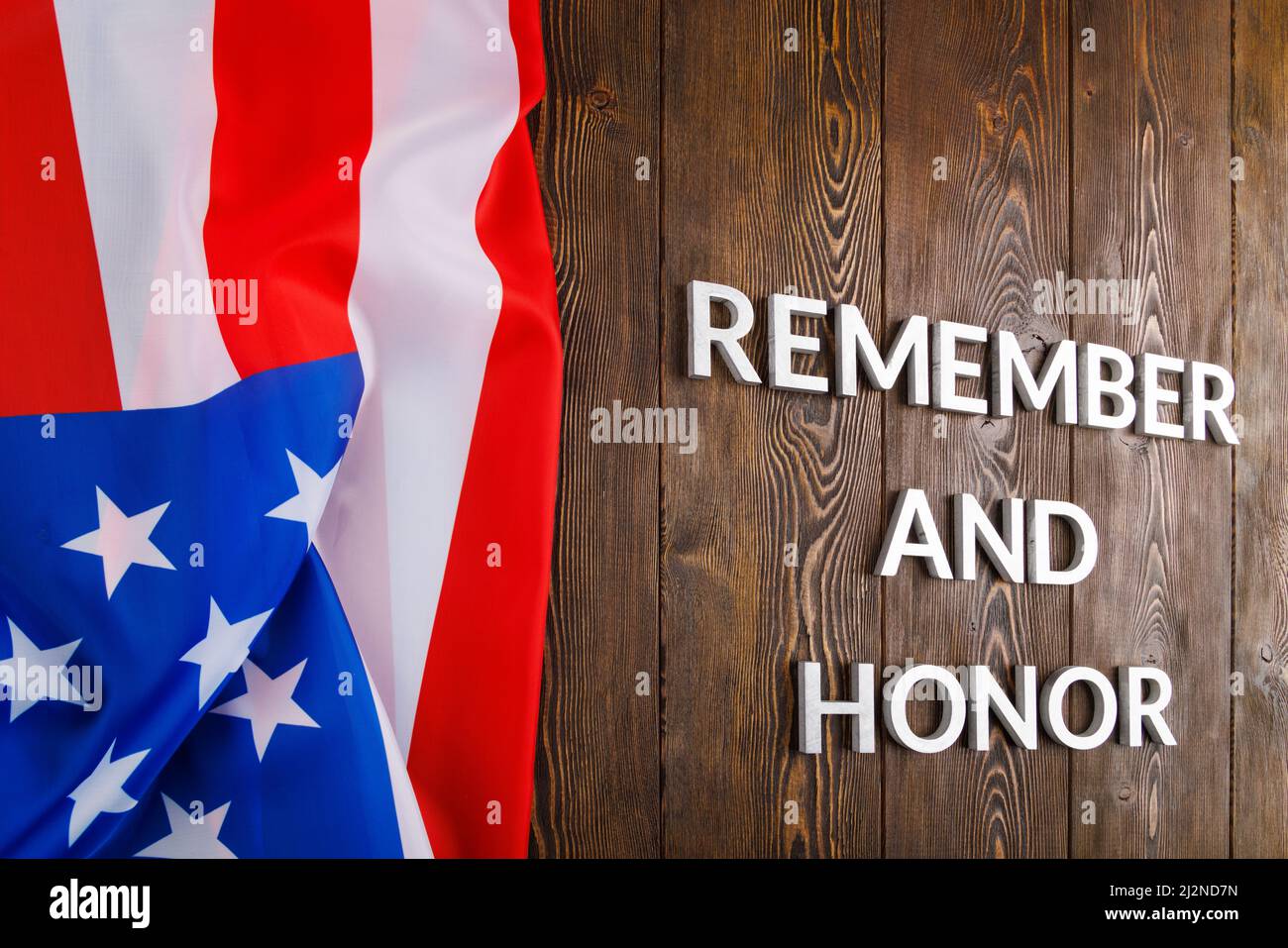 words remember and honor laid with silver metal letters on wooden ...