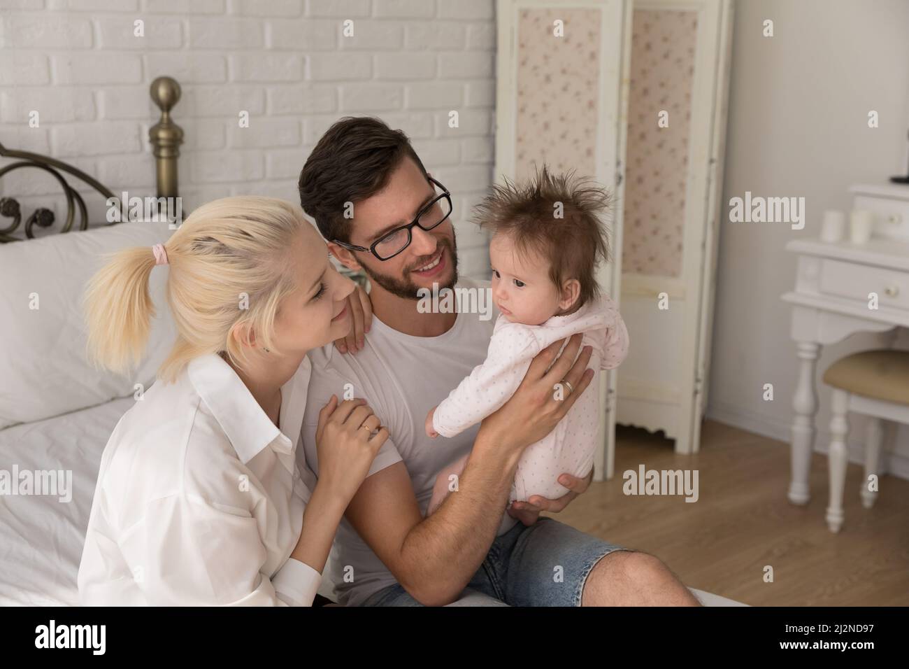 Happy young new mom and dad enjoying parenthood Stock Photo - Alamy