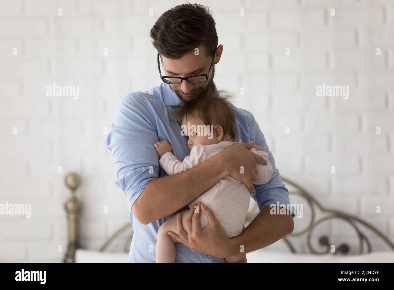 Caring dad holding rocking, calming adorable baby, holding little daughter Stock Photo - Alamy