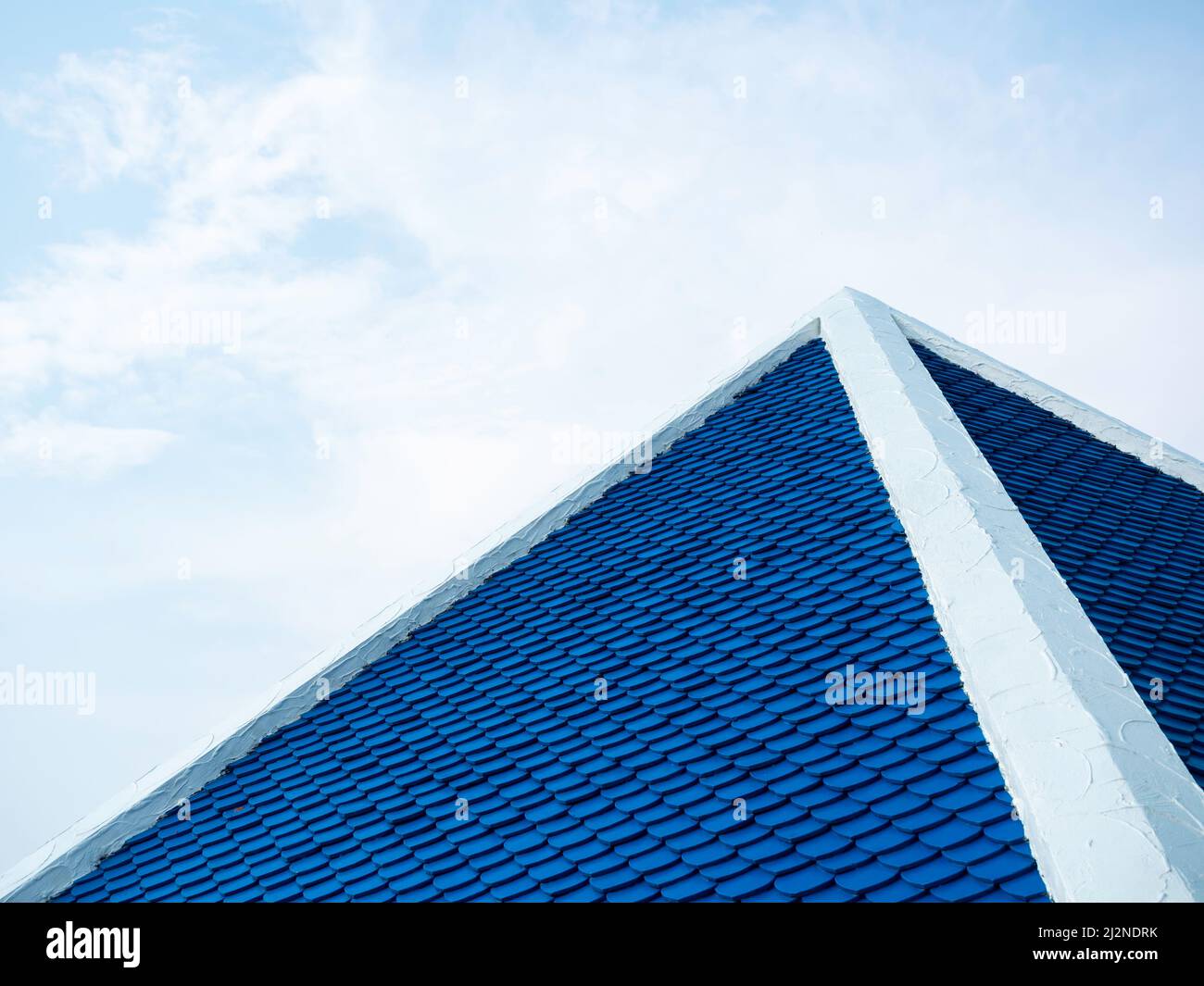 Arrangement of blue house roof tiles in white cement edge frame on the ...